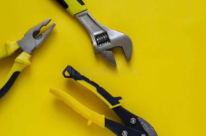 Hand Tools with Black and Yellow Handles on a Yellow Background Stock ...