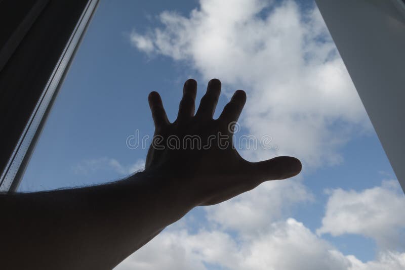 A Hand Touched the Window Pane. the Sky in the Background Stock Photo ...