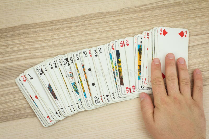 Hand touches deck of cards stock photo. Image of freetime - 63056932
