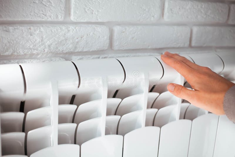 Hand touches the radiator stock photo. Image of purchase - 149827456