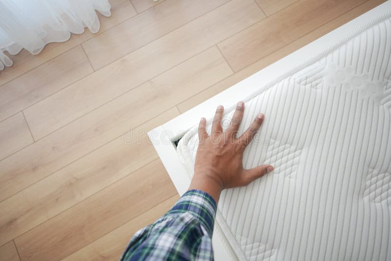 Hand Touching and Pressing Orthopedic Mattress on Bed. Stock Image ...