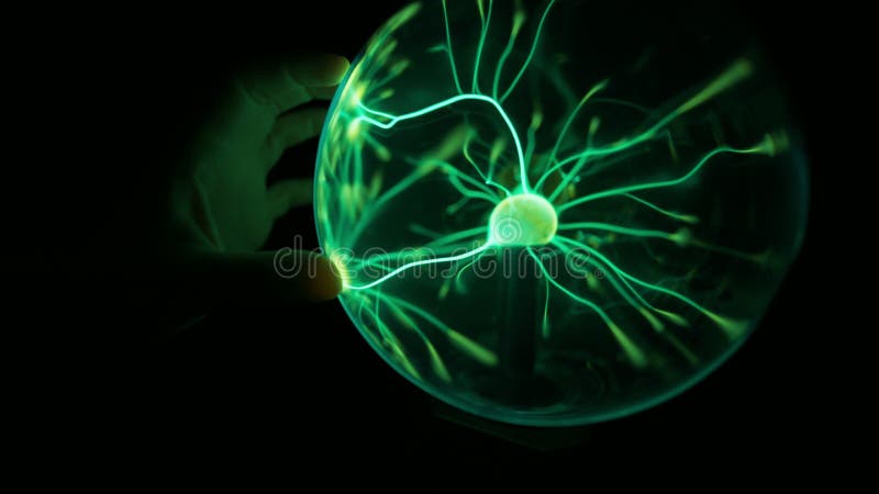 A Hand Touching the Surface of Electric Plasma Ball with Green Rays ...