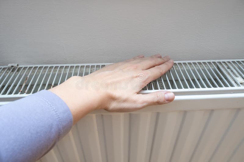 A Hand Touching White Radiator of a Central Heating System, Checking ...