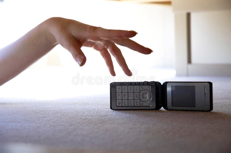 A Hand Trying To Grab a Hand Phone. Conceptual Image Shot Stock Photo ...