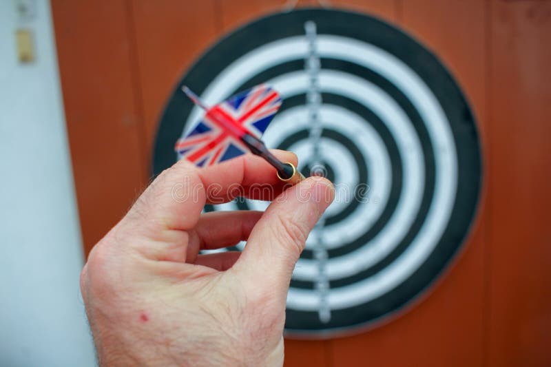 Hand Trying To Hit the Arrow in the Center of the Target Stock Photo ...