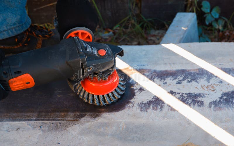 Hand with a Turbine Removes Rust from Metal. Man Using Angle Grinder ...