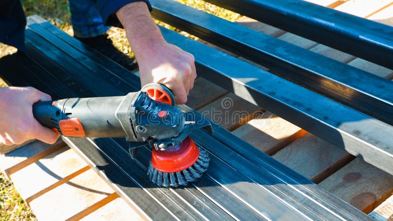 Hand with a Turbine Removes Rust from Metal. Man Using Angle Grinder ...