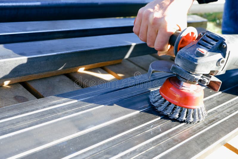 Hand with a Turbine Removes Rust from Metal. Man Using Angle Grinder ...