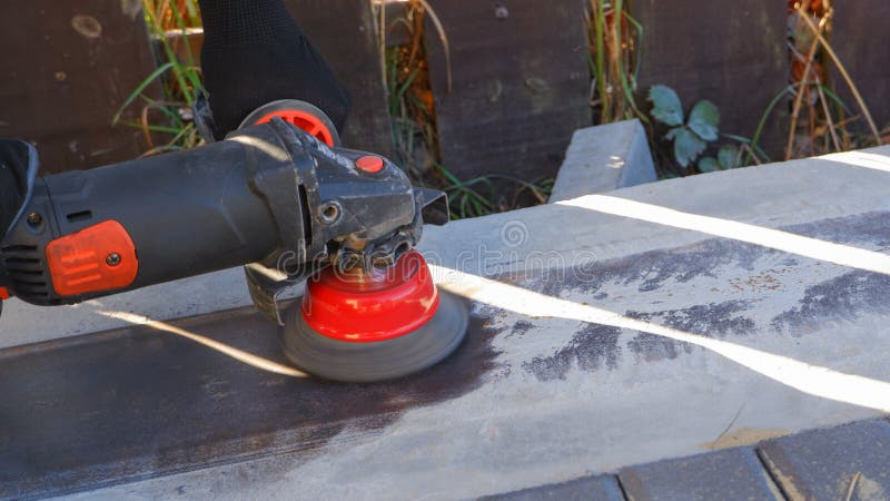 Hand with a Turbine Removes Rust from Metal. Man Using Angle Grinder ...