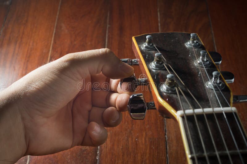 Hand Turning Acoustic Guitar. Stock Image - Image of acoustic, sound ...