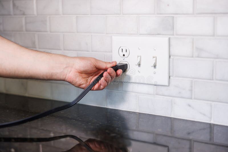 Hand Plugging in Electrical Cord into Home Outlet Stock Image - Image ...