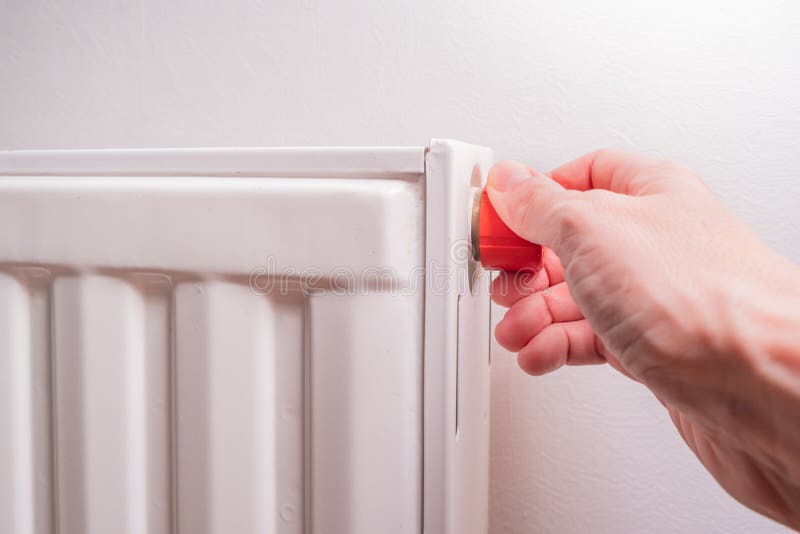 A Hand Turning the Thermostat, Temperature Control on a Radiator of a ...
