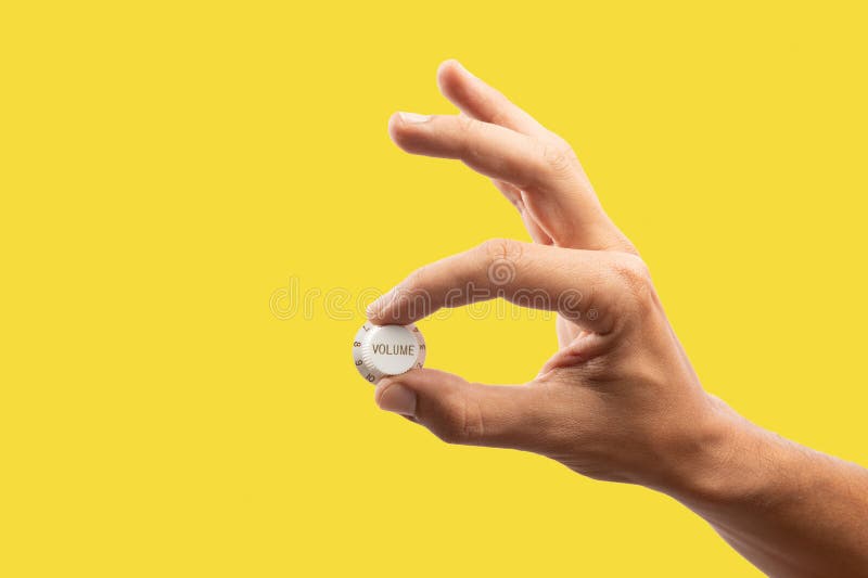 Hand Turning Volume Control Knob Isolated on Yellow Stock Image - Image ...