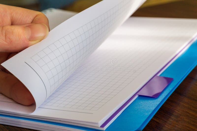 Hand Turns the Blank Sheet of Notebook on a Wooden Table. Flip Notebook ...