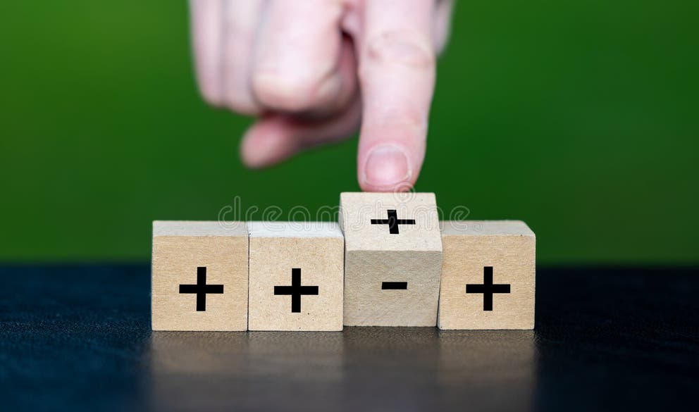 Hand Turns Cube and Changes a Minus Sign To a Plus Sign. Stock Photo ...