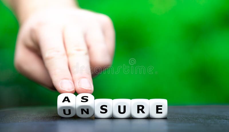 Hand Turns Dice and Changes the Word Unsure To Assure Stock Image ...