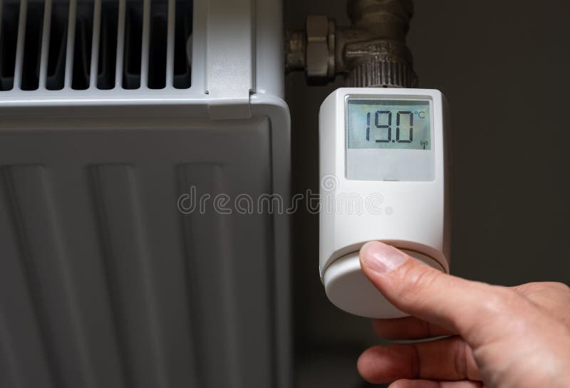 Hand Turns Down the Temperature To 19 Degrees Celsius on a Electronic ...
