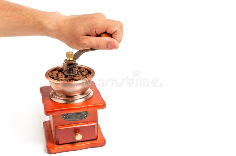 Hand Turns the Handle of a Wooden Coffee Grinder on a White Background ...