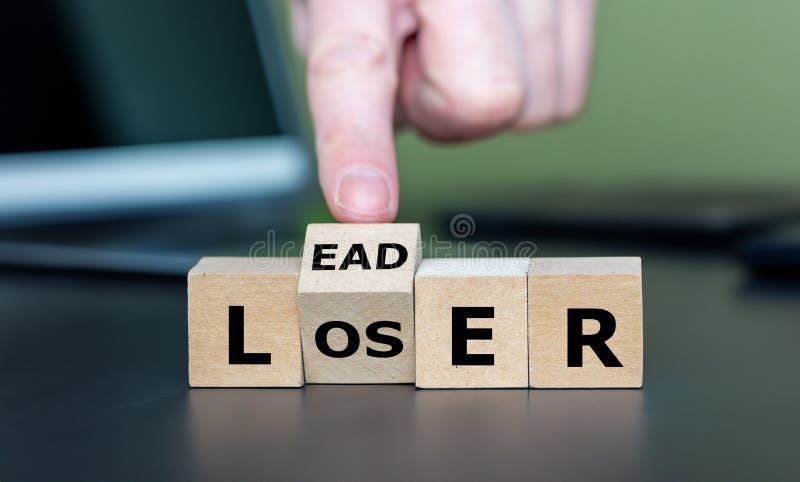 Hand Turns Wooden Cube and Changes the Word Loser To Leader. Stock ...