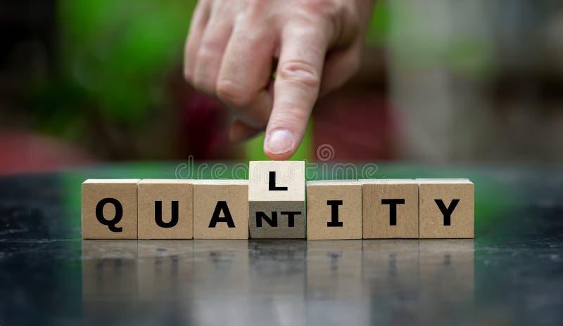 Hand Turns Wooden Cube and Changes the Word Quantity To Quality. Stock ...