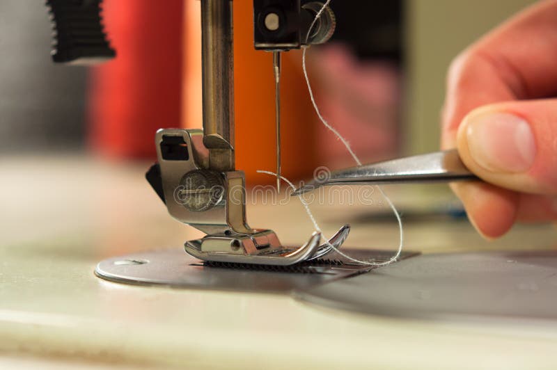 Hand with Tweezers Gives the Thread the Needle of the Sewing Machine ...