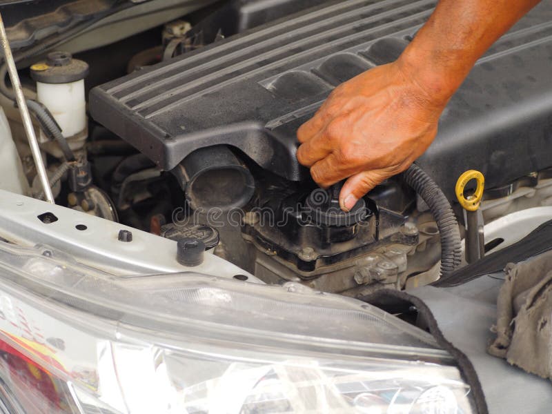 Hand is Twisting the Engine Oil Cap.Car Maintenance Technician he is ...