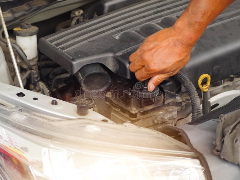 Hand is Twisting the Engine Oil Cap.Car Maintenance Technician he is ...