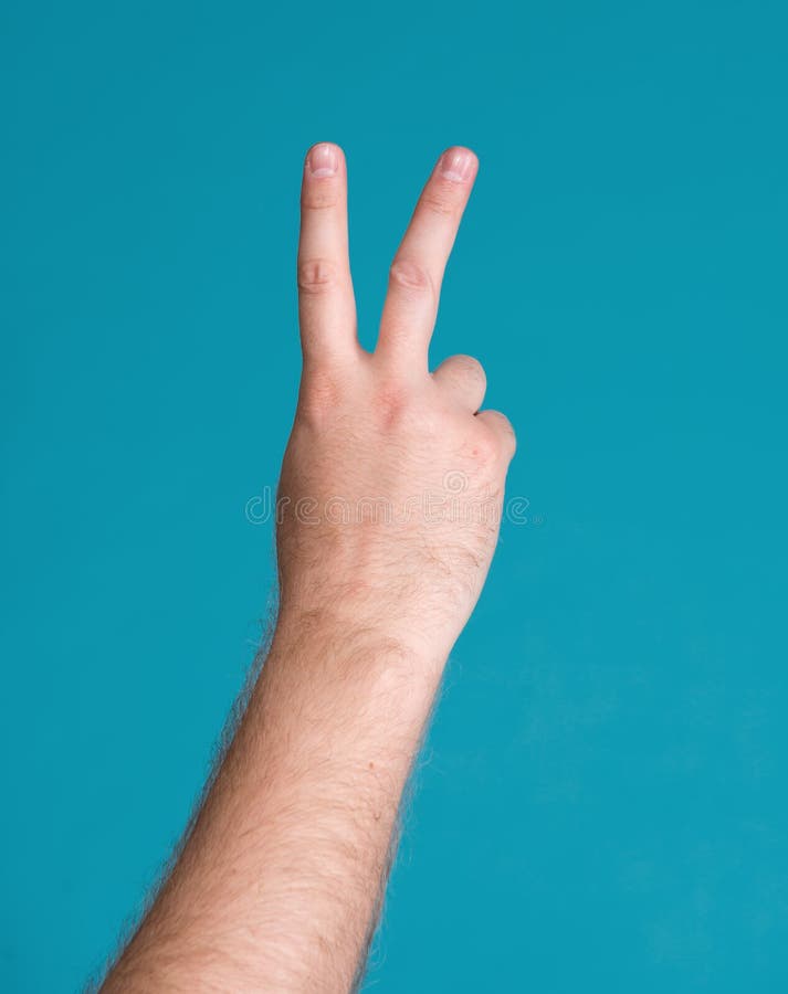 Hand with Two Fingers Up in the Peace or Victory Symbol Stock Photo ...
