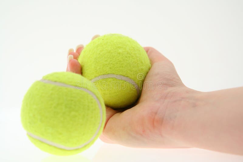Hand with two tennis balls stock image. Image of green - 805619