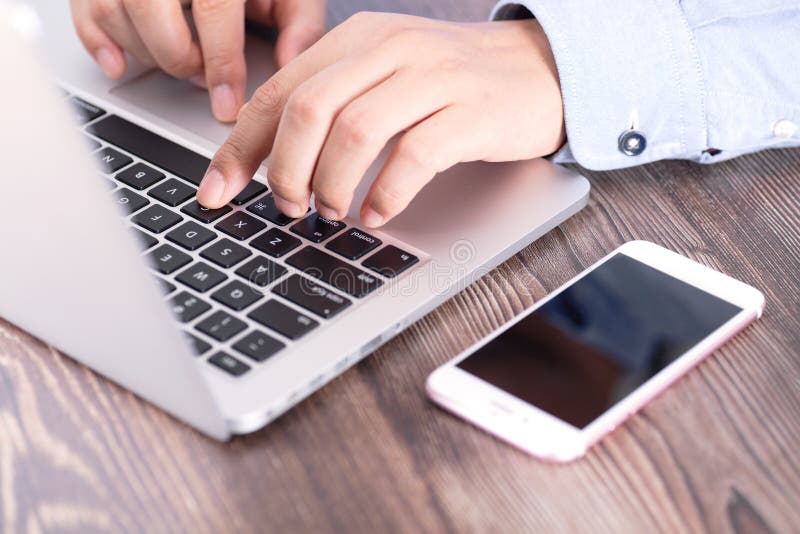 Hand Typing on Keyboard and a Mobile Phone Editorial Image - Image of ...