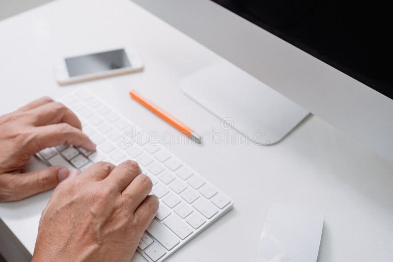 Hand Typing White Computer Keyboard of Desktop Computer on White Desk ...