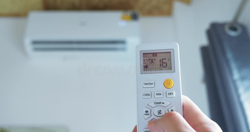A Hand Uses Remote Control Technology Lower Air Conditioner Temperature ...