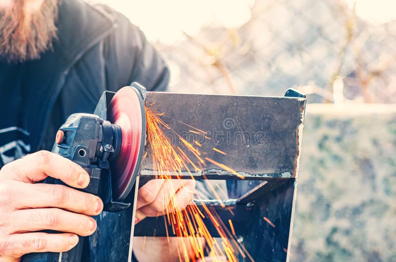 Hand Using Angle Grinder To Cut Metal with Sparks in Construction Site ...