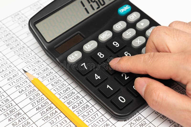 Hand Using Calculator on Financial Spreadsheet for Budgeting and ...
