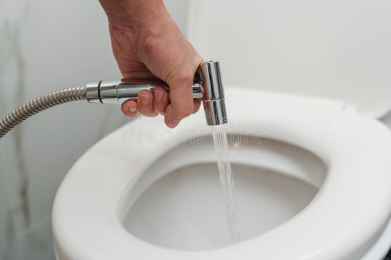Hand Using Chromium Bidet Shower Spraying in Toilet Bowl Stock Photo ...