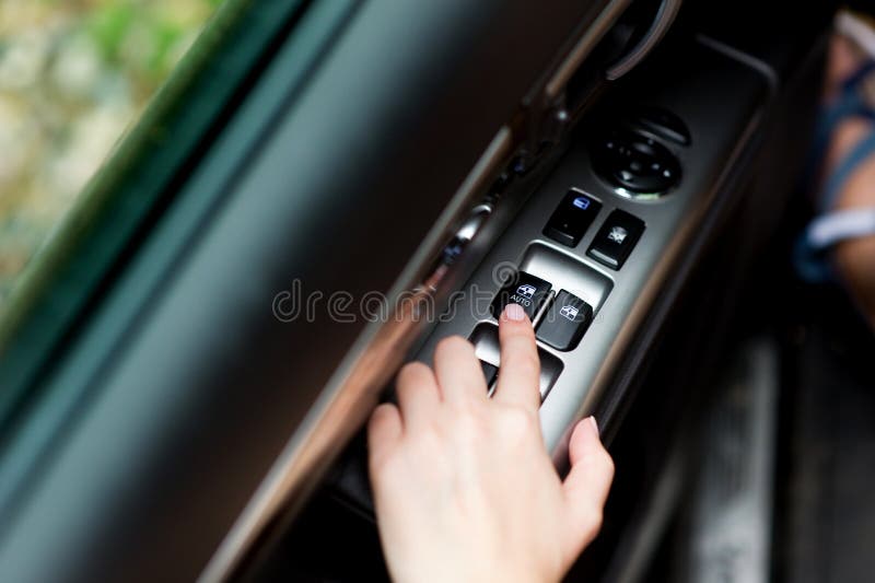 Girl is Going To Lower the Glass in the Car with the Power Window ...