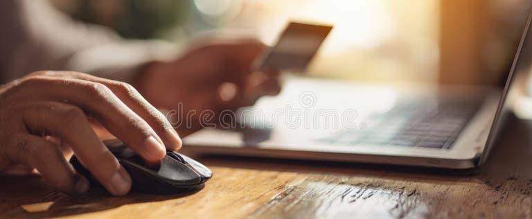The Hand Using a Mouse while Making an Online Payment with a Credit ...