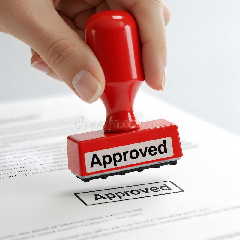 A Hand Using a Red Approved Stamp on a Document in a Close Up View ...