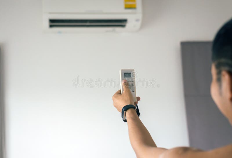 Hand Using a Remote Control To Activating Air Conditioning in Room ...