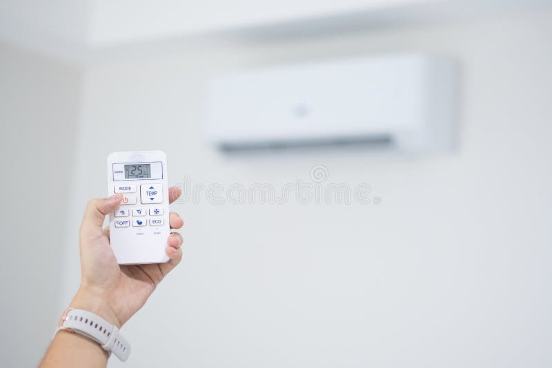 Hand Using Remote Controller for Adjust Air Conditioner Inside the Room ...