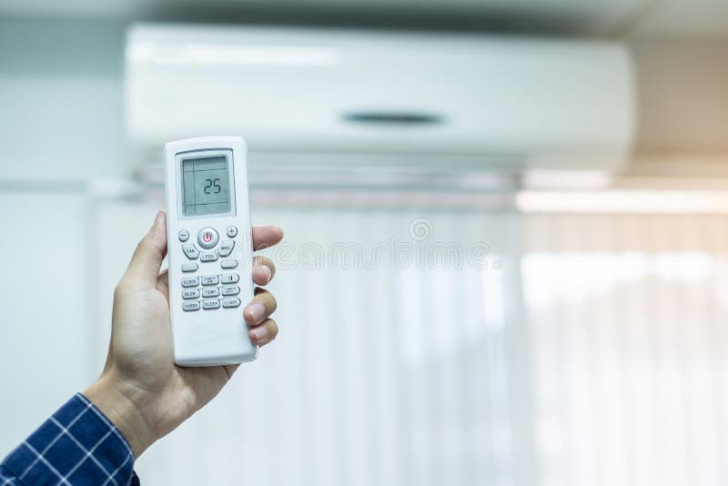 Hand Using Remote Controller for Adjust Air Conditioner Inside the Room ...