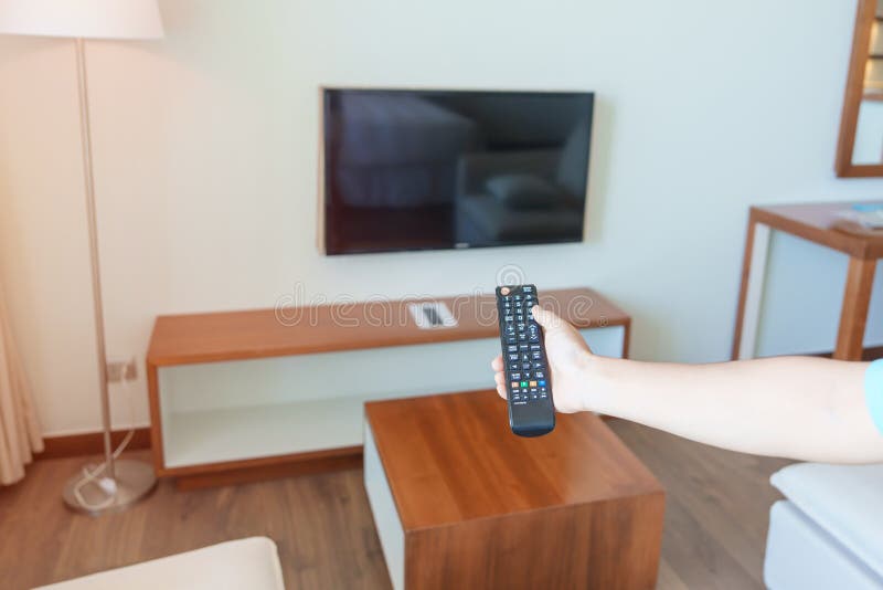 Hand Using Remote Controller for Adjust Smart TV Inside the Modern Room ...