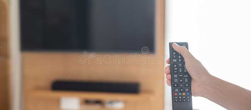 Hand Using Remote Controller for Adjust Smart TV Inside the Modern Room ...