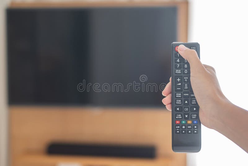 Hand Using Remote Controller for Adjust Smart TV Inside the Modern Room ...