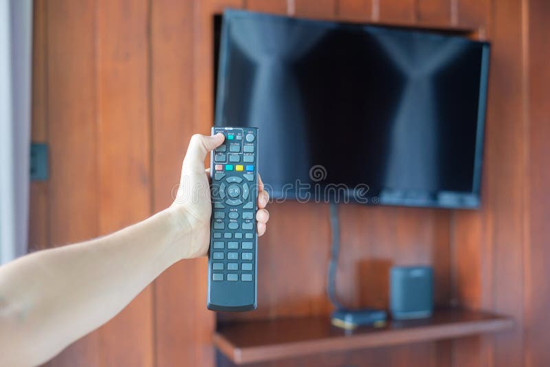 Hand Using Remote Controller for Adjust Smart TV Inside the Modern Room ...