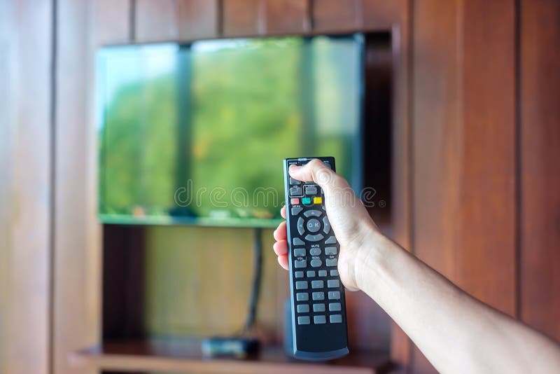 Hand Using Remote Controller for Adjust Smart TV Inside the Modern Room ...