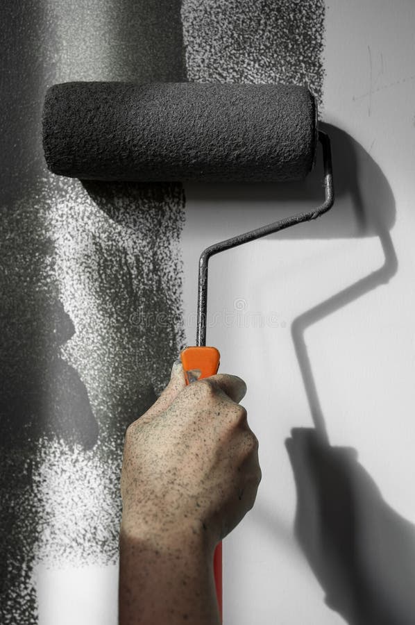 Hand Using Roller Paint Applying Grey Paint on White Wall. Stock Photo ...