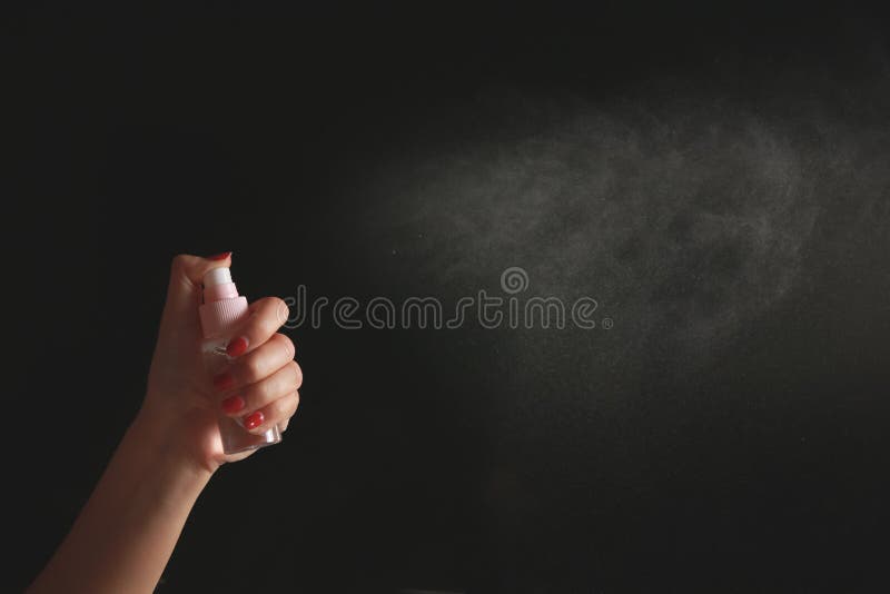 Hand Using a Spray, Isolated on Black Background Stock Photo - Image of ...