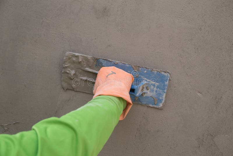Hand Using Trowel To Finish Wet Concrete Wall at Construction Si Stock ...