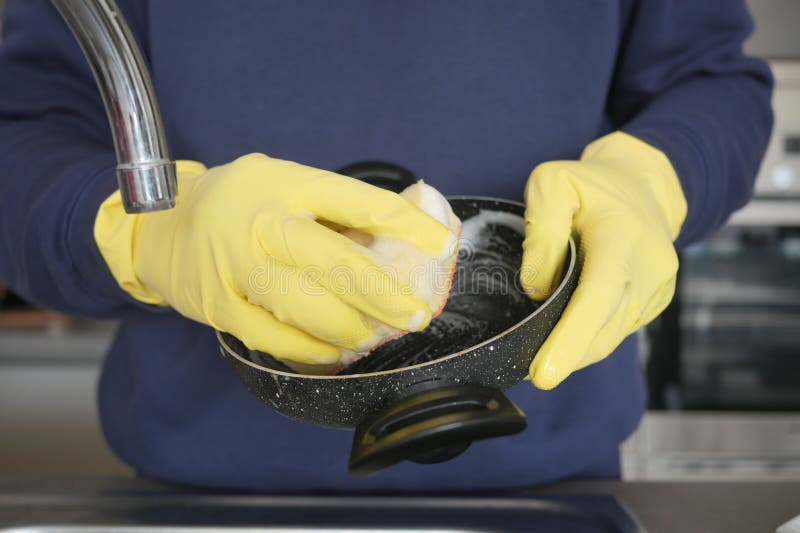 Hand washing a cooking pan stock image. Image of work - 289974269
